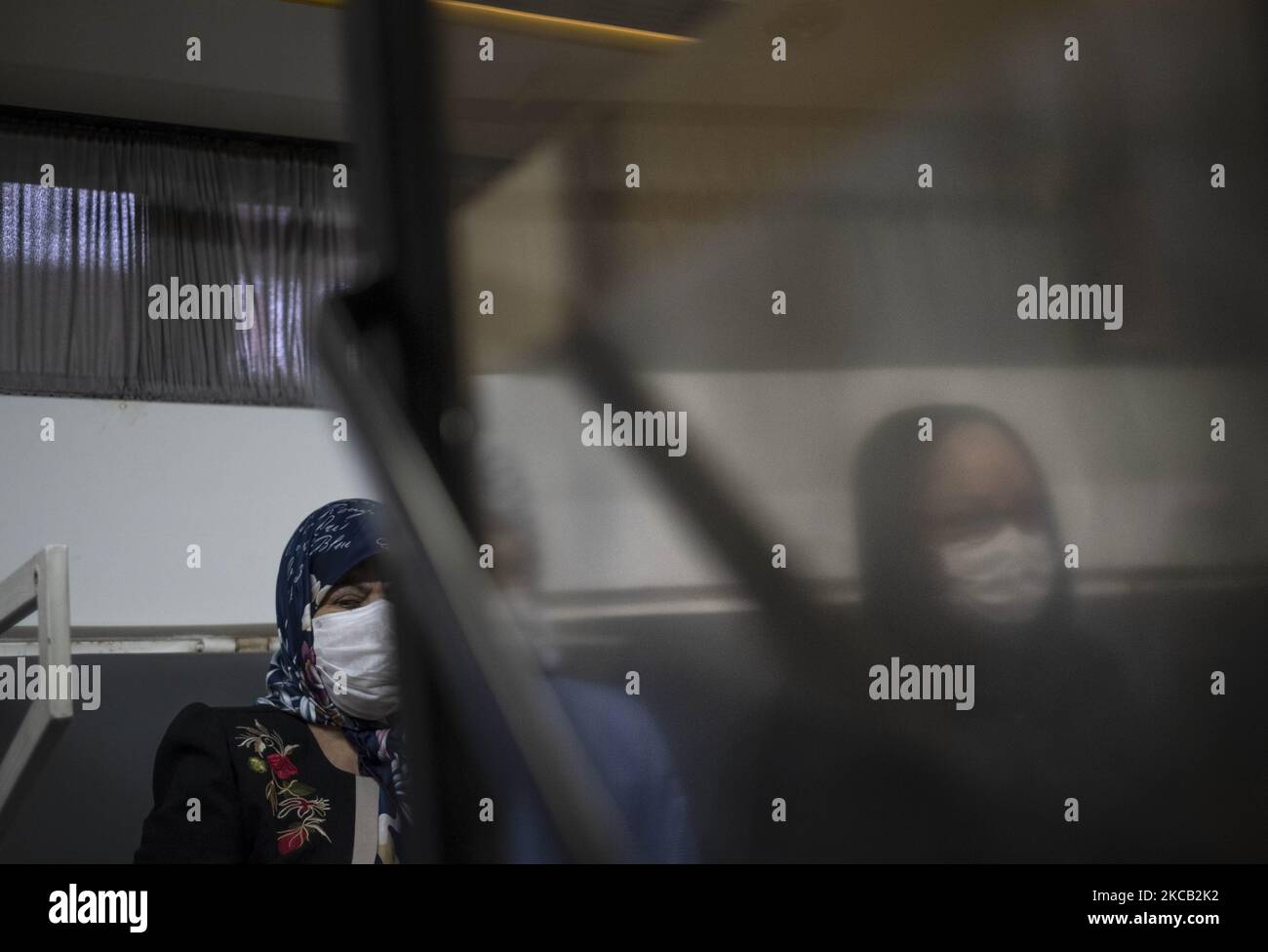 Two Iranian women who have infected by the COVID-19, wearing protective ...