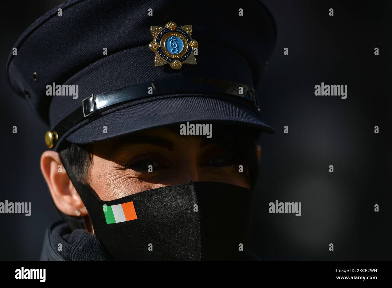 A member of Garda Siochana (Irish Police) wearing a face mask with an ...