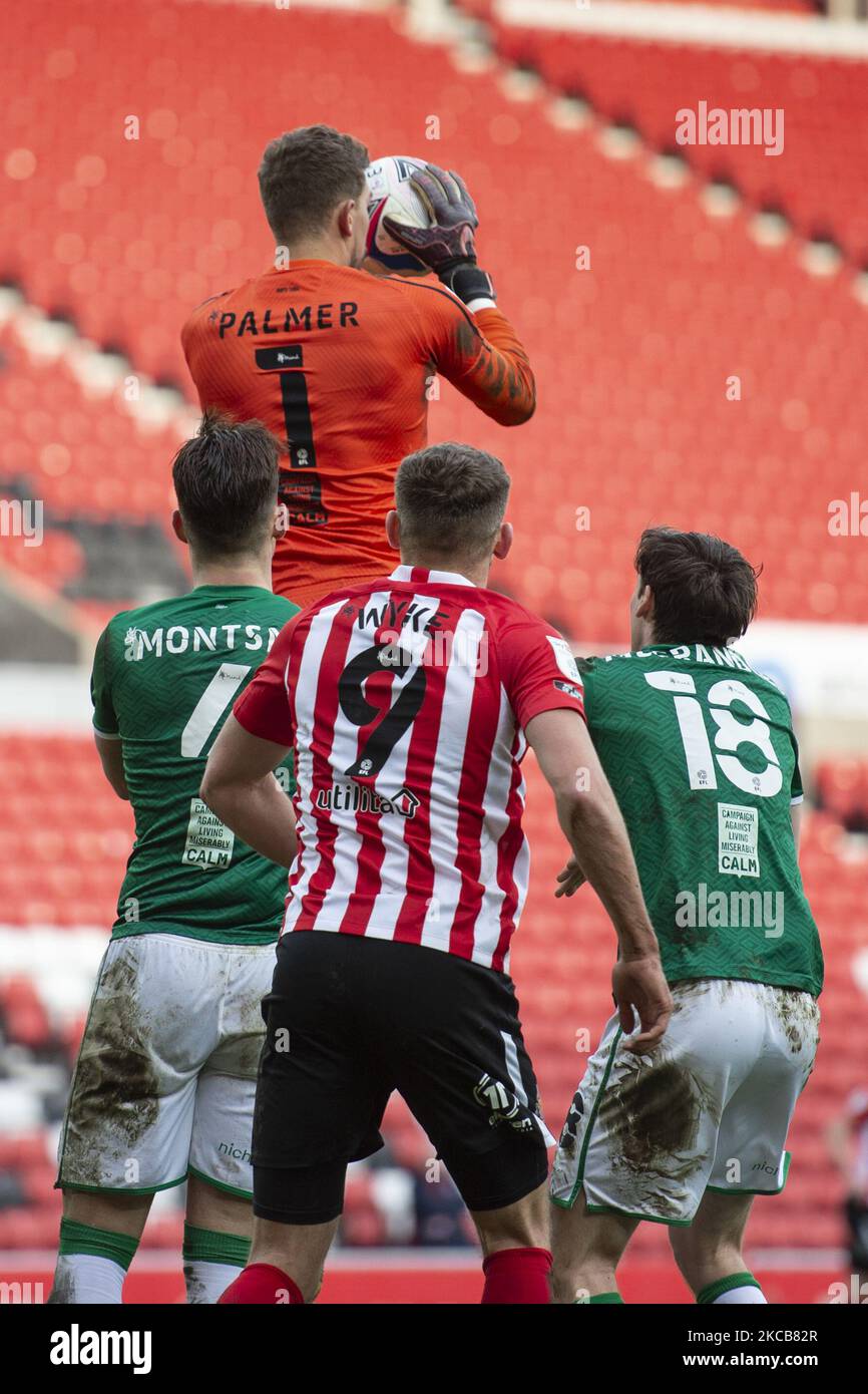 Lincoln City goalkeeper Alex Palmer catches the ball from a corner ...