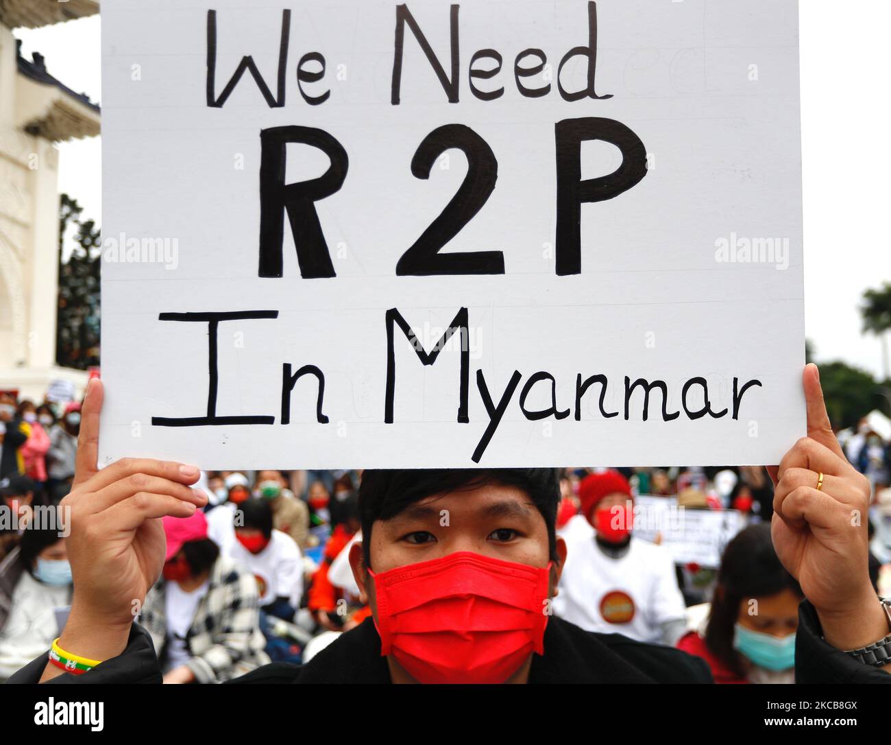 Hundreds of Burmese, monks and Taiwanese chant slogans, hold portraits ...