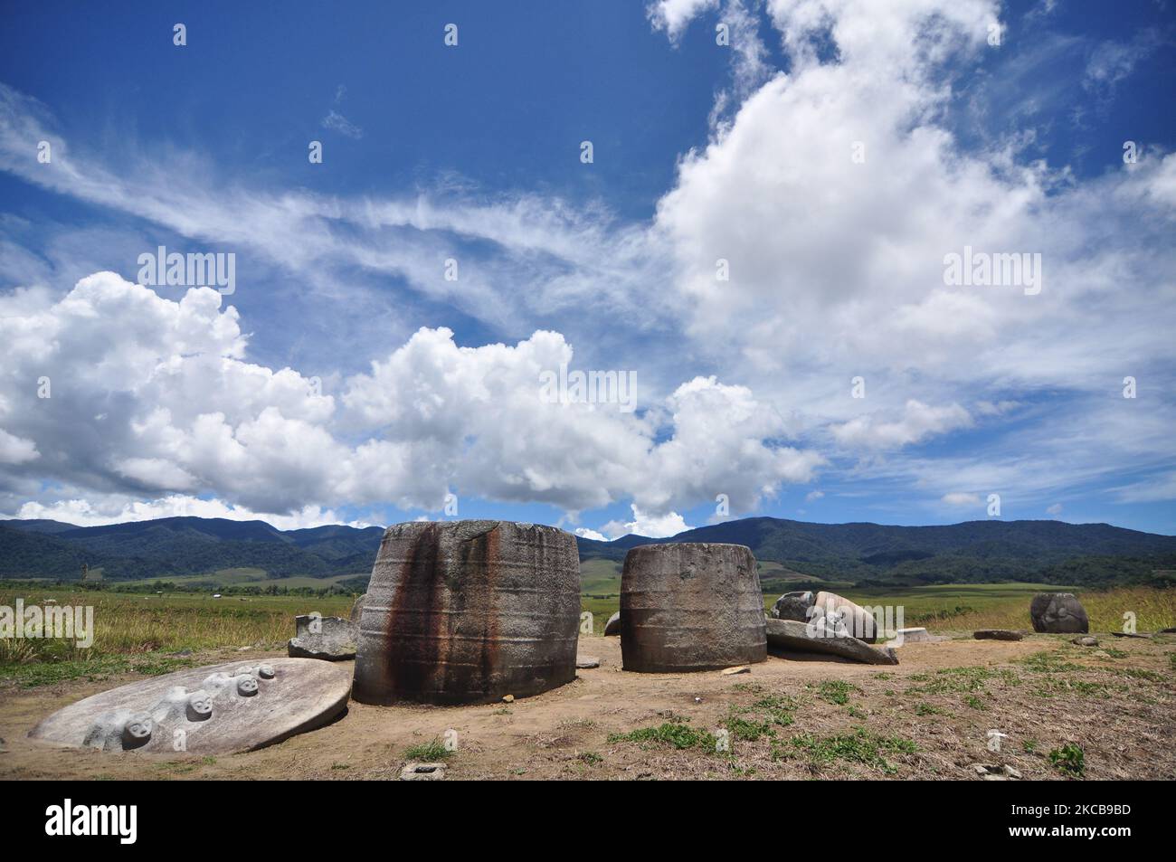 Megalithic objects shaped like water reservoirs with carved human faces ...