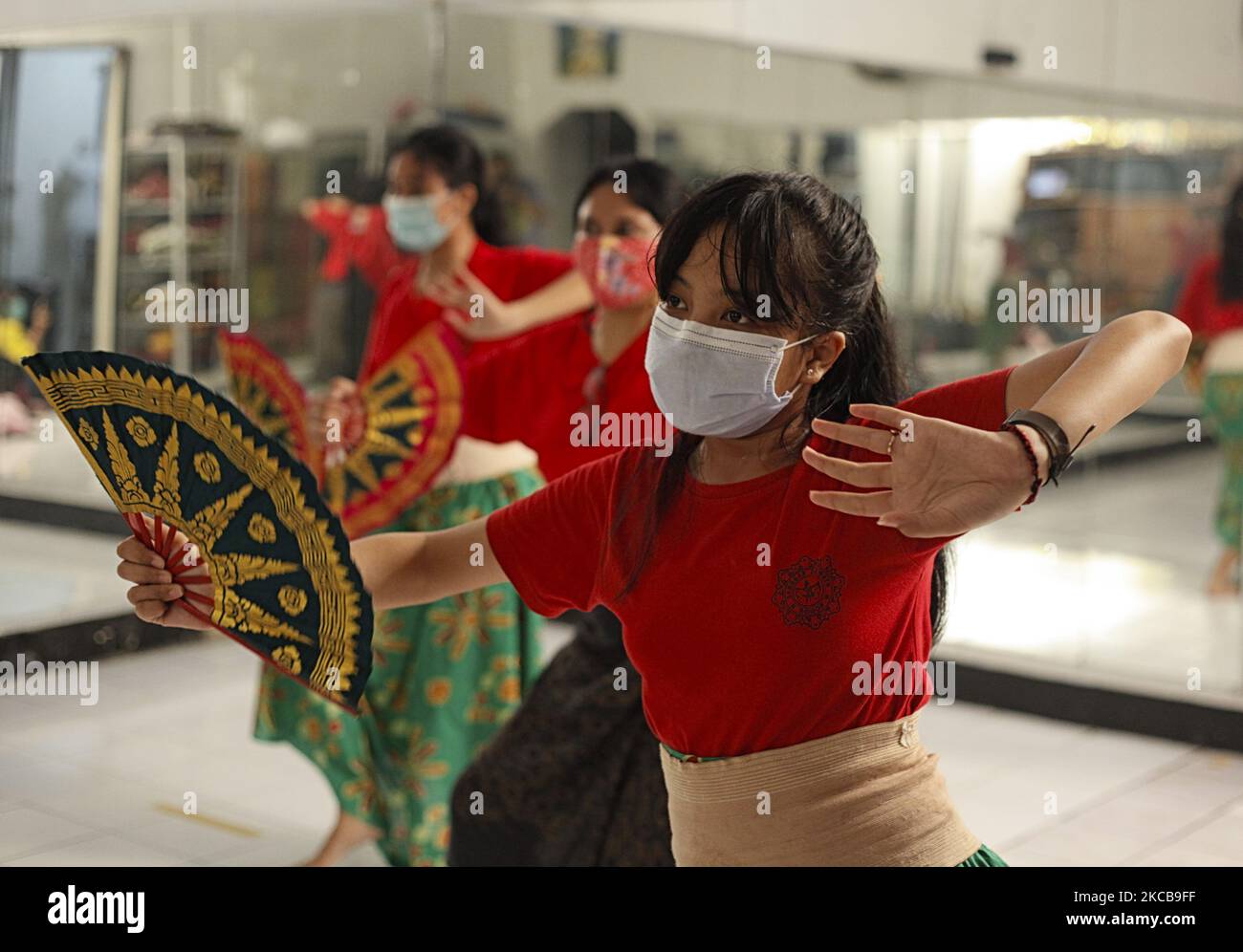 Balinese children wear protective mask practice a traditional dance at ...