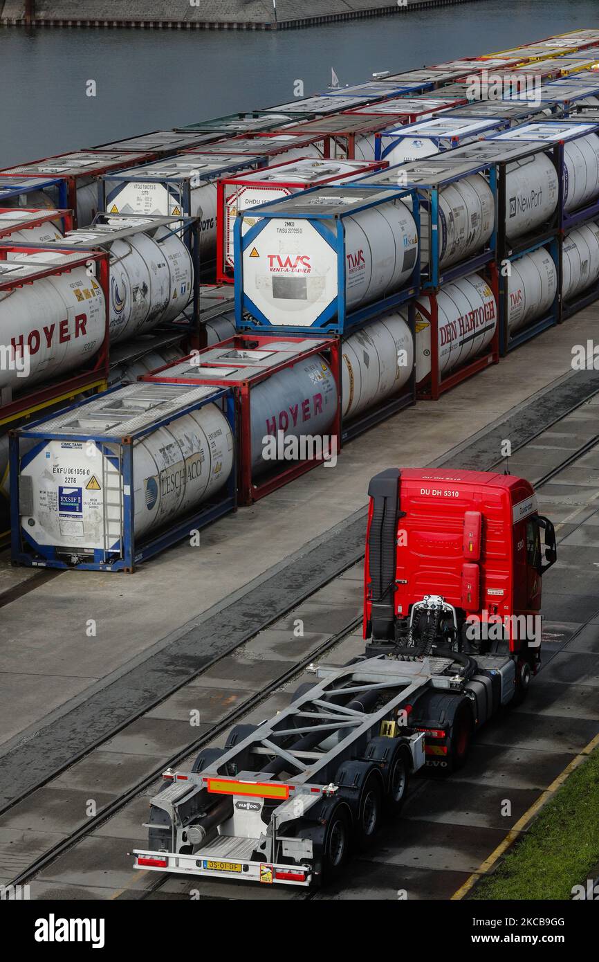 A cargo vehicle is seen in front of a pile of containers at the ...
