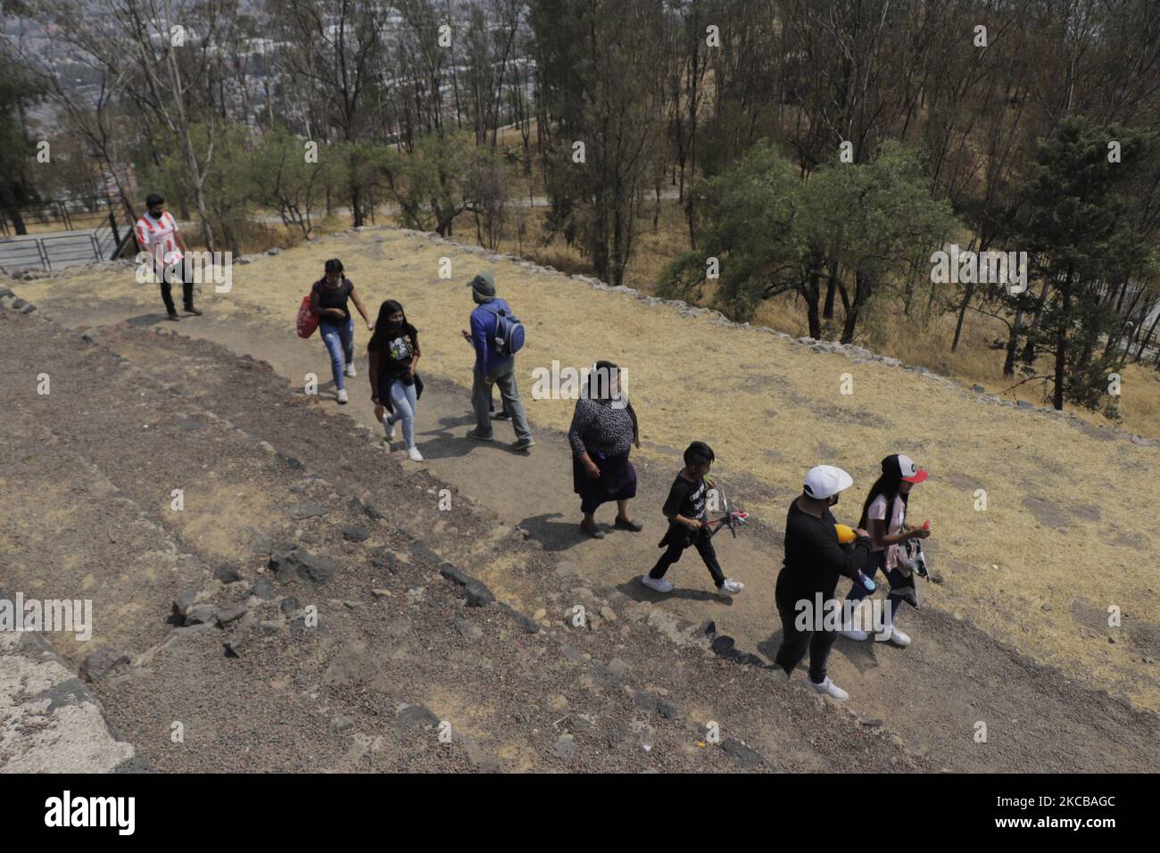 A family climbs the archaeological site of Cerro de la Estrella ...
