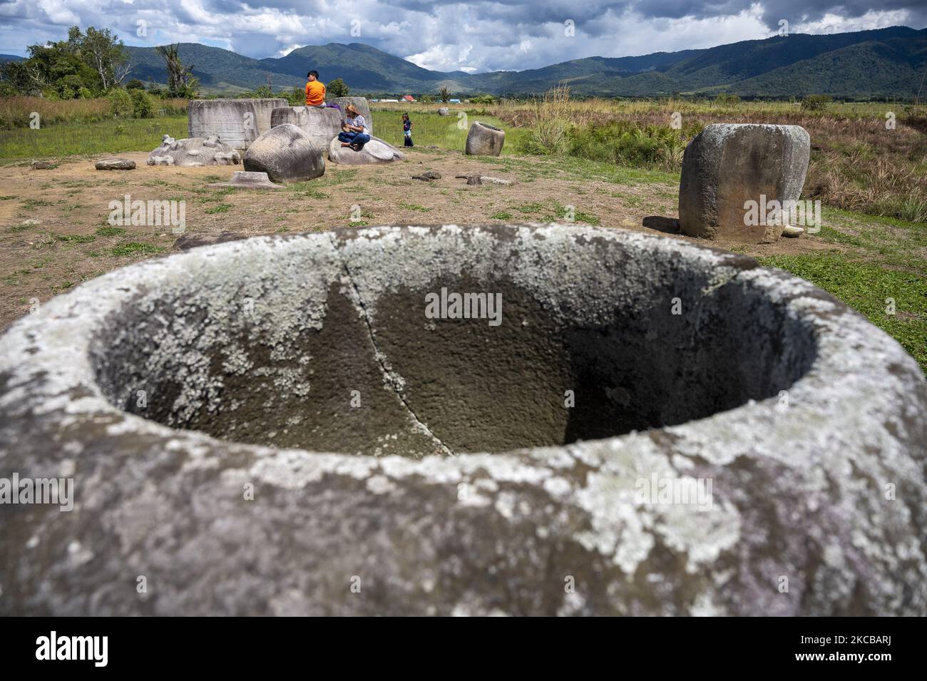 Tourists take pictures while visiting the Pokokea Megalith Site in ...