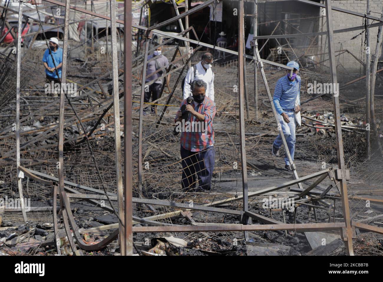 Shopkeepers guide experts after a major fire broke out at the San ...
