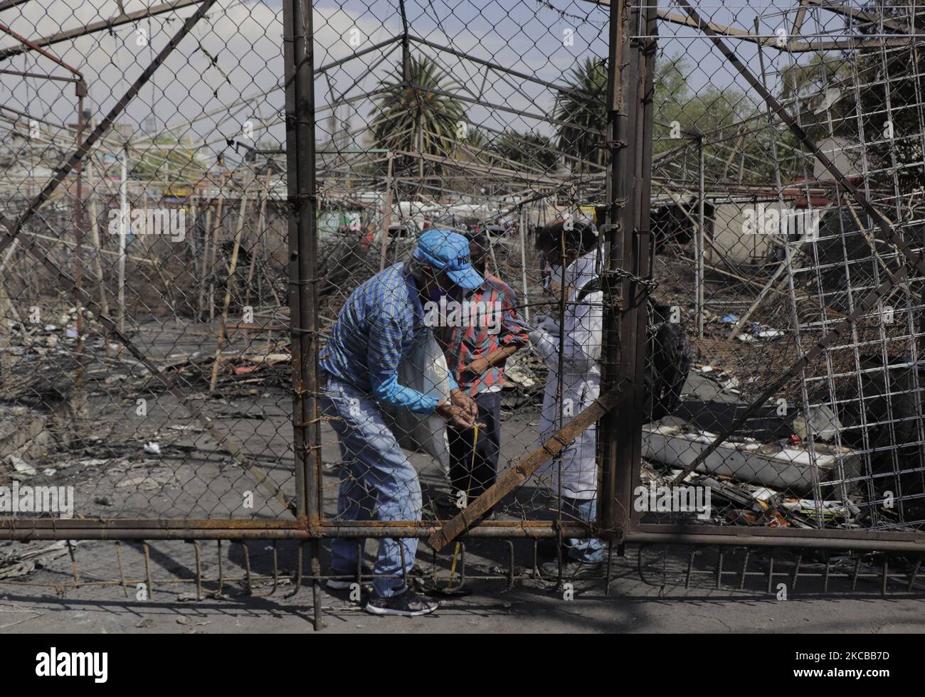 Shopkeepers guide experts after a major fire broke out at the San ...