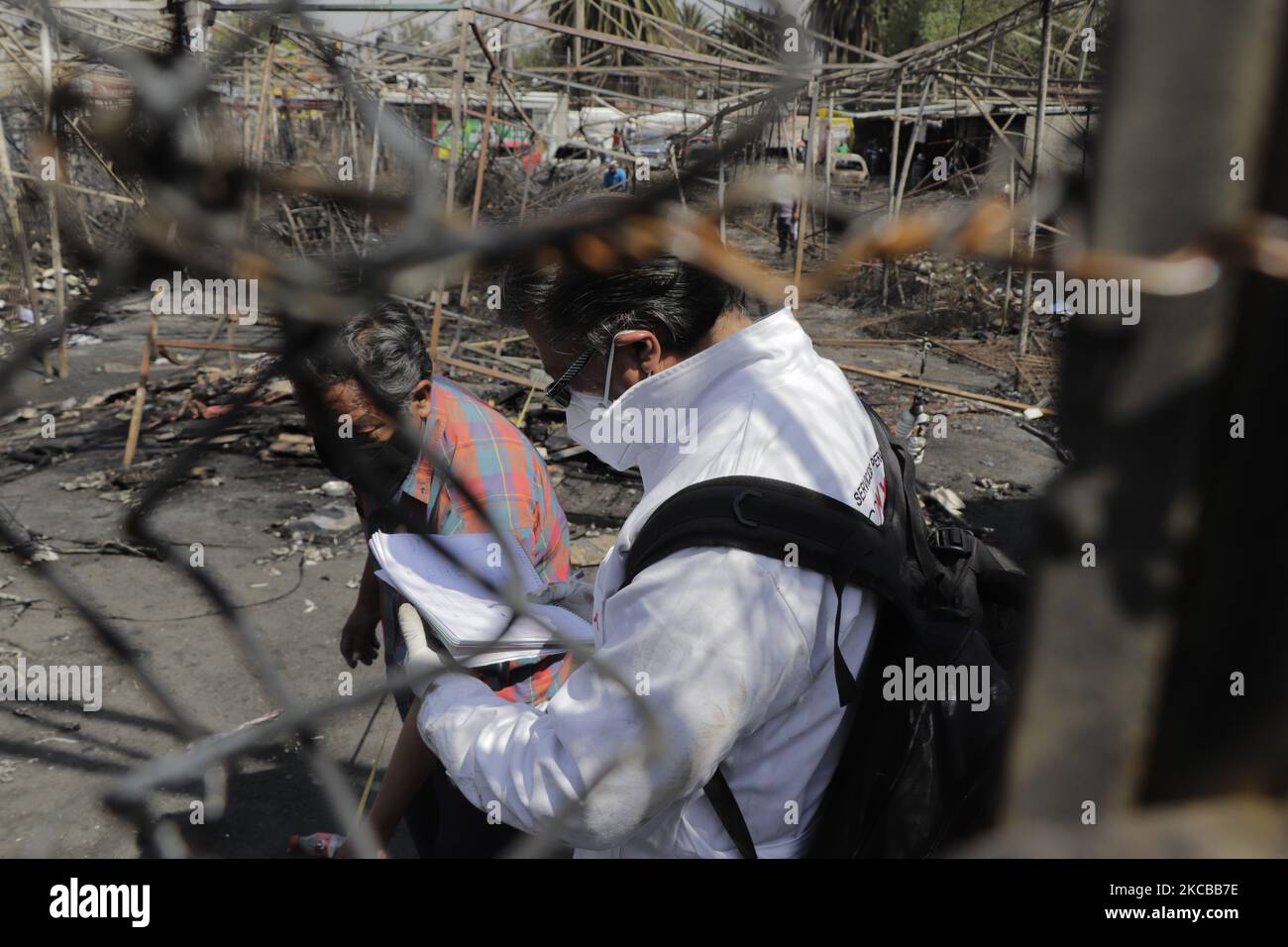 Shopkeepers guide experts after a major fire broke out at the San ...