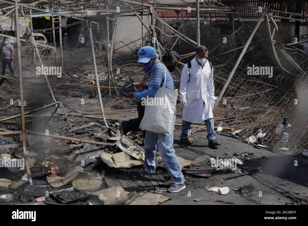 Shopkeepers guide experts after a major fire broke out at the San ...