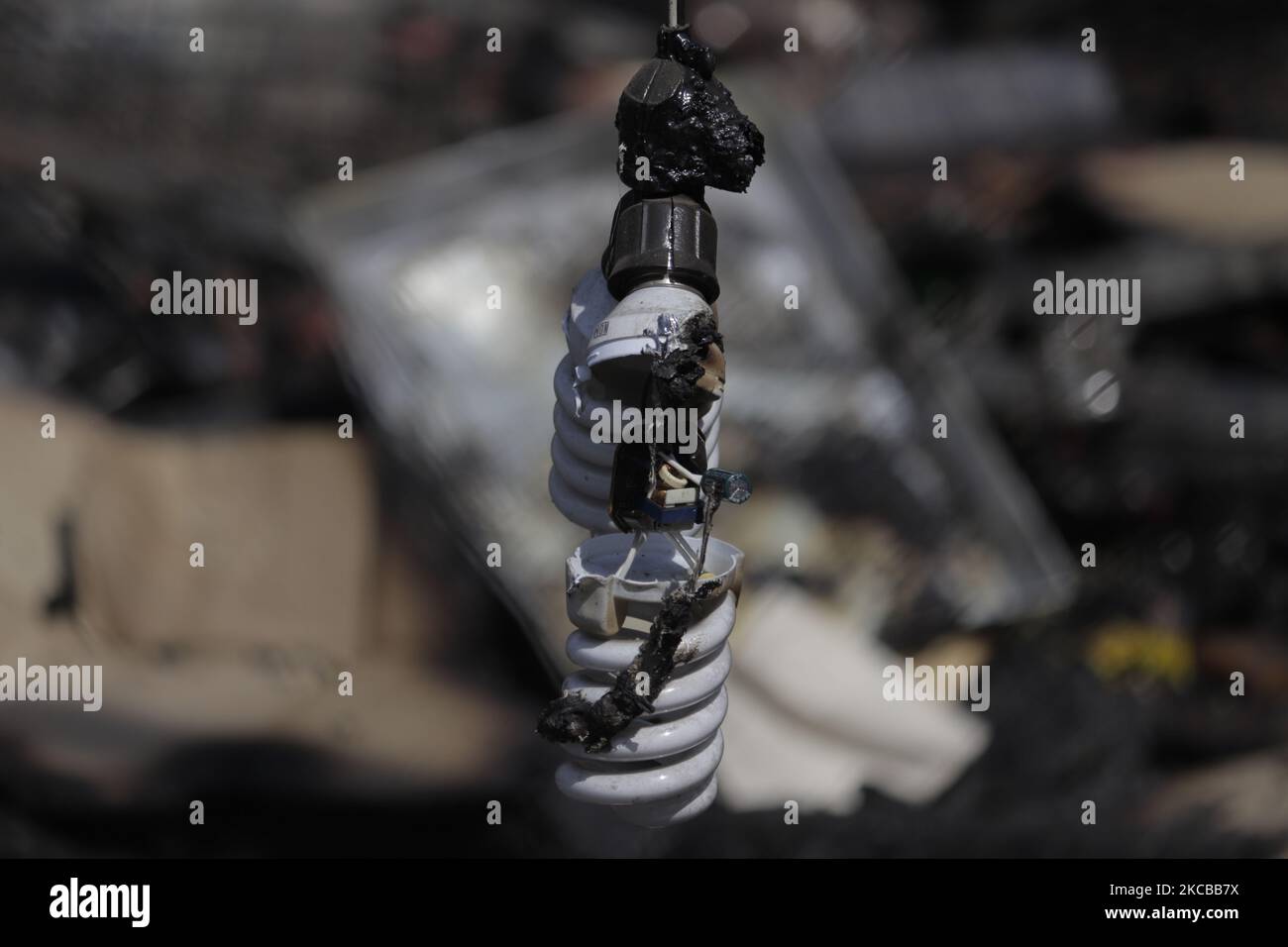 Charred material remains after a strong fire broke out at the San ...