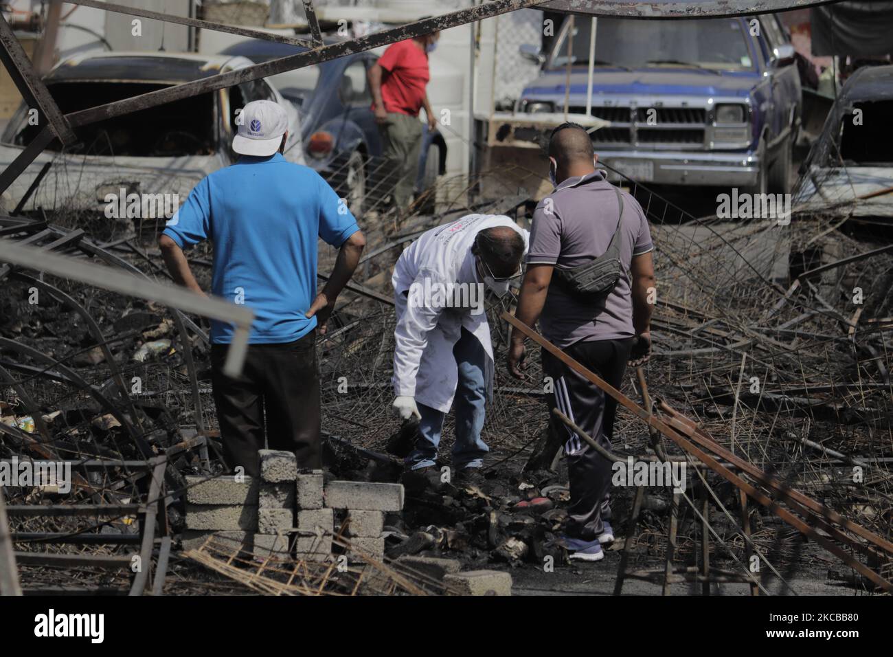 Shopkeepers guide experts after a major fire broke out at the San ...