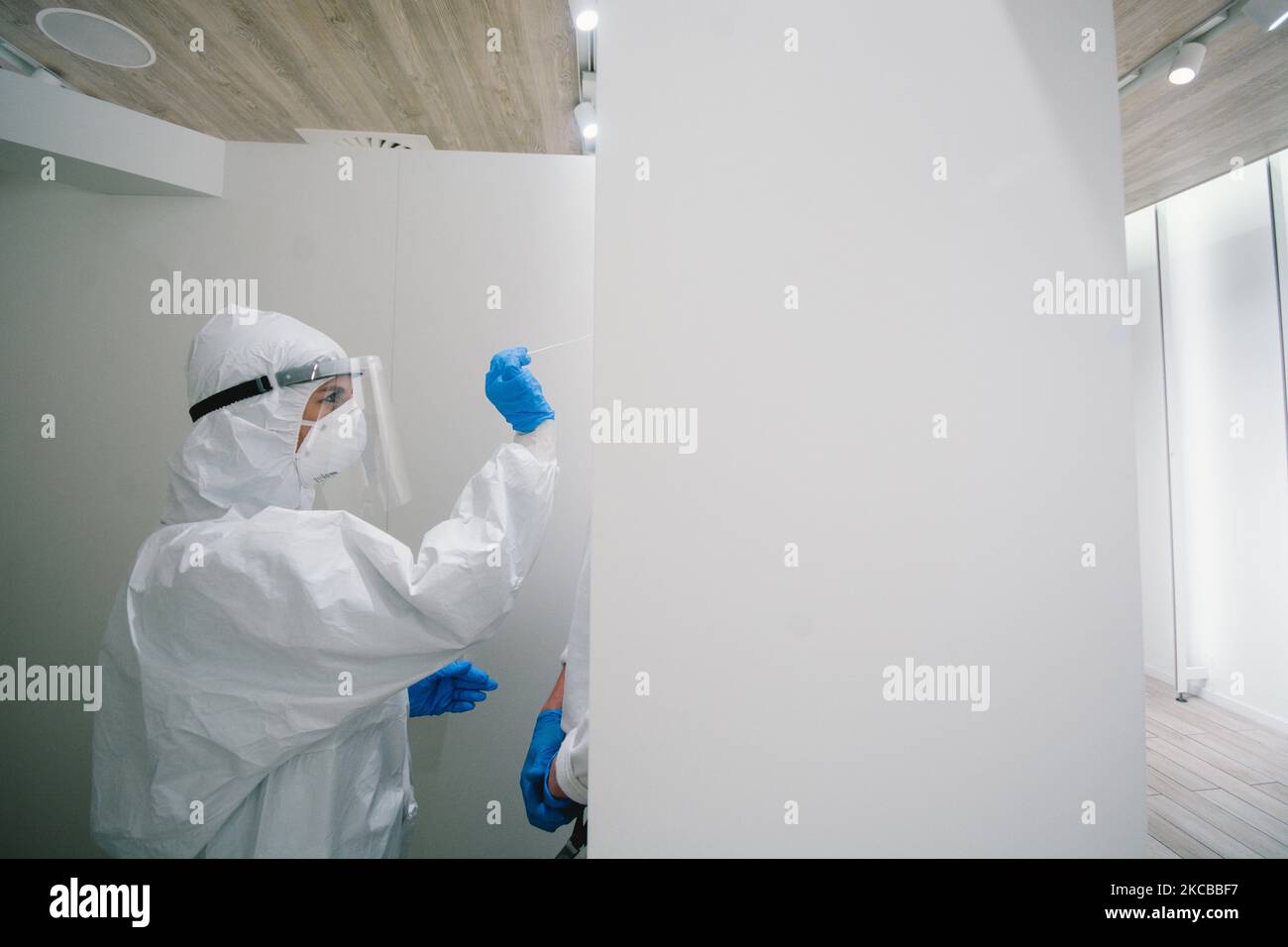 a medical worker administer a corona rapid test as a new coronavirus ...