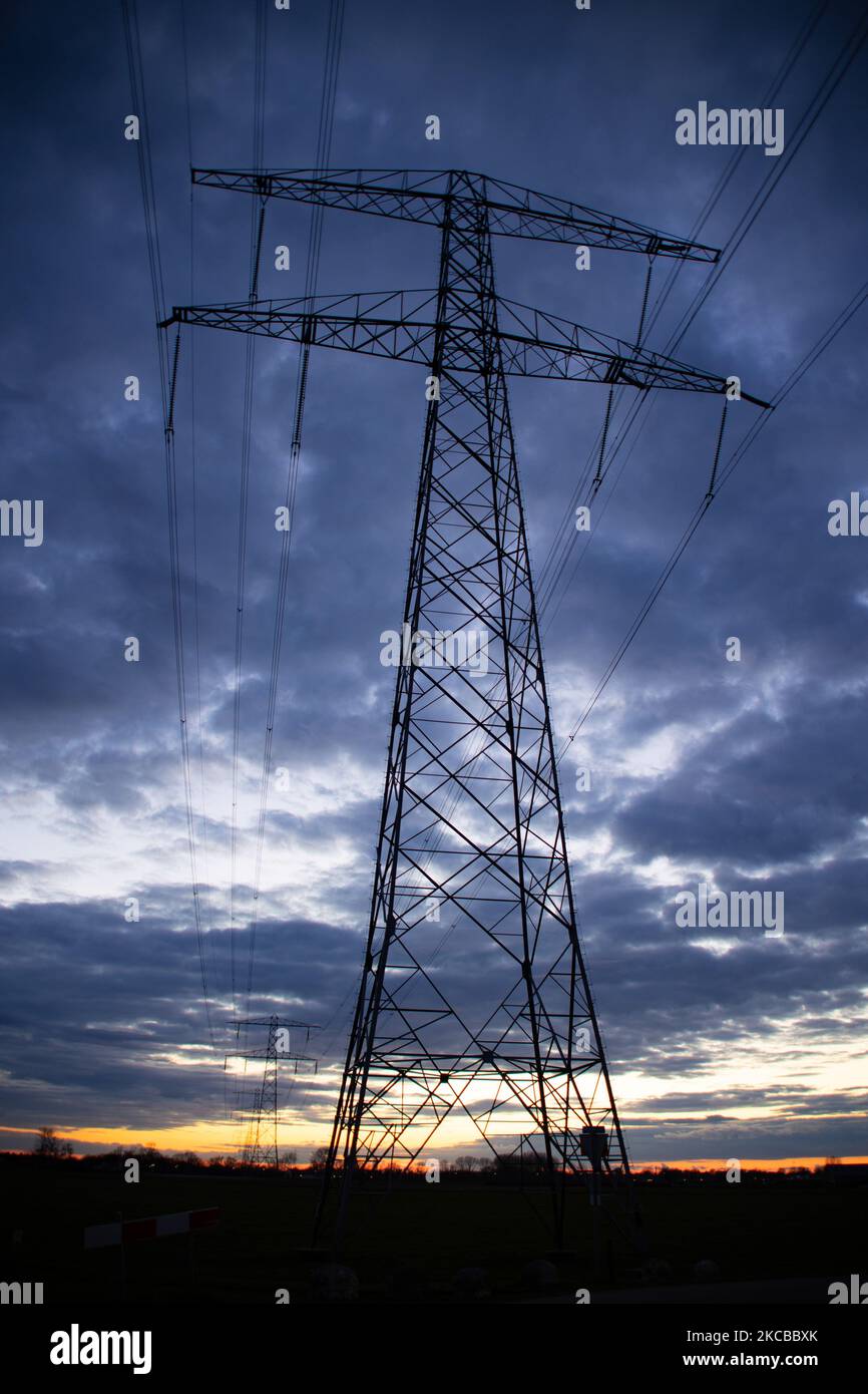 High voltage electricity poles during magic hour. The metal towers as ...