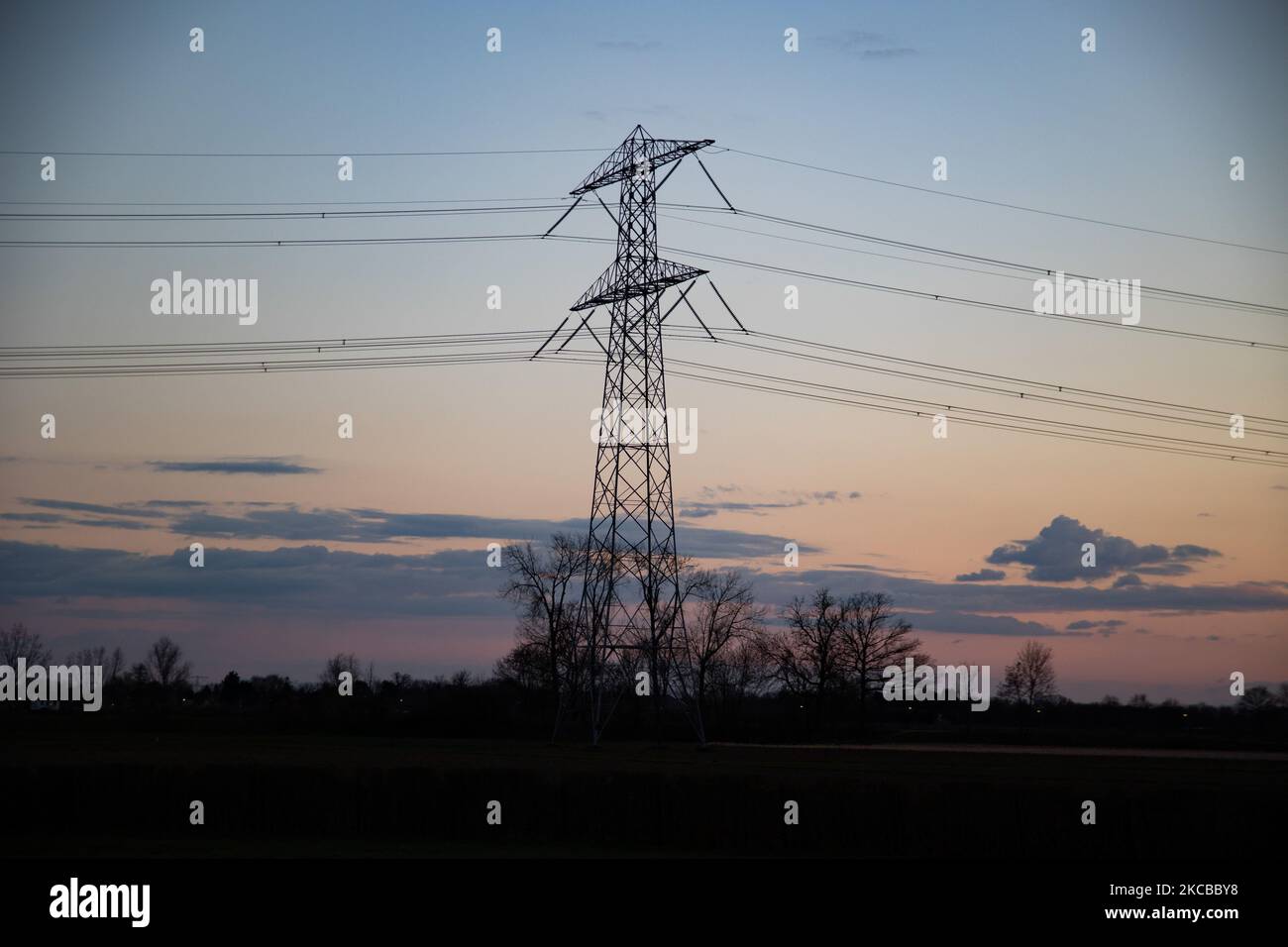 High voltage electricity poles during magic hour. The metal towers as ...