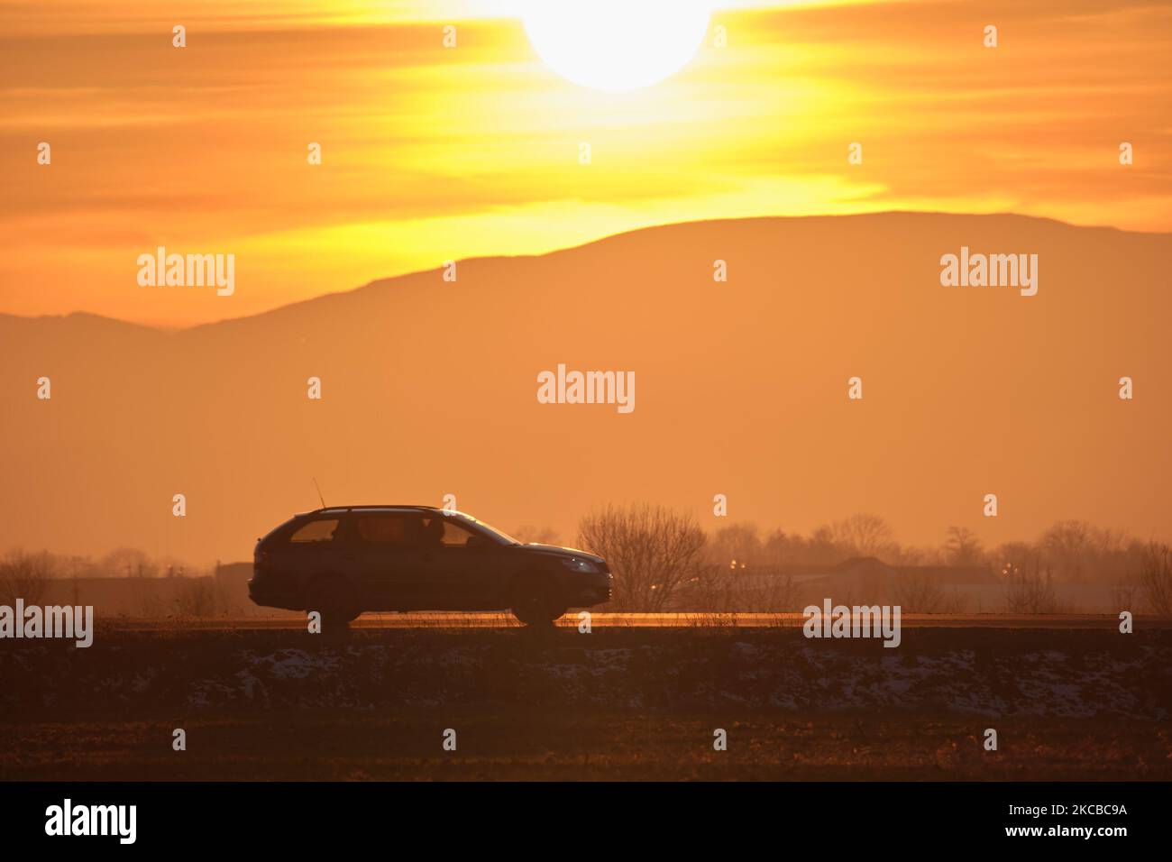 Car driving fast on intercity road at sunset. Highway traffic in ...