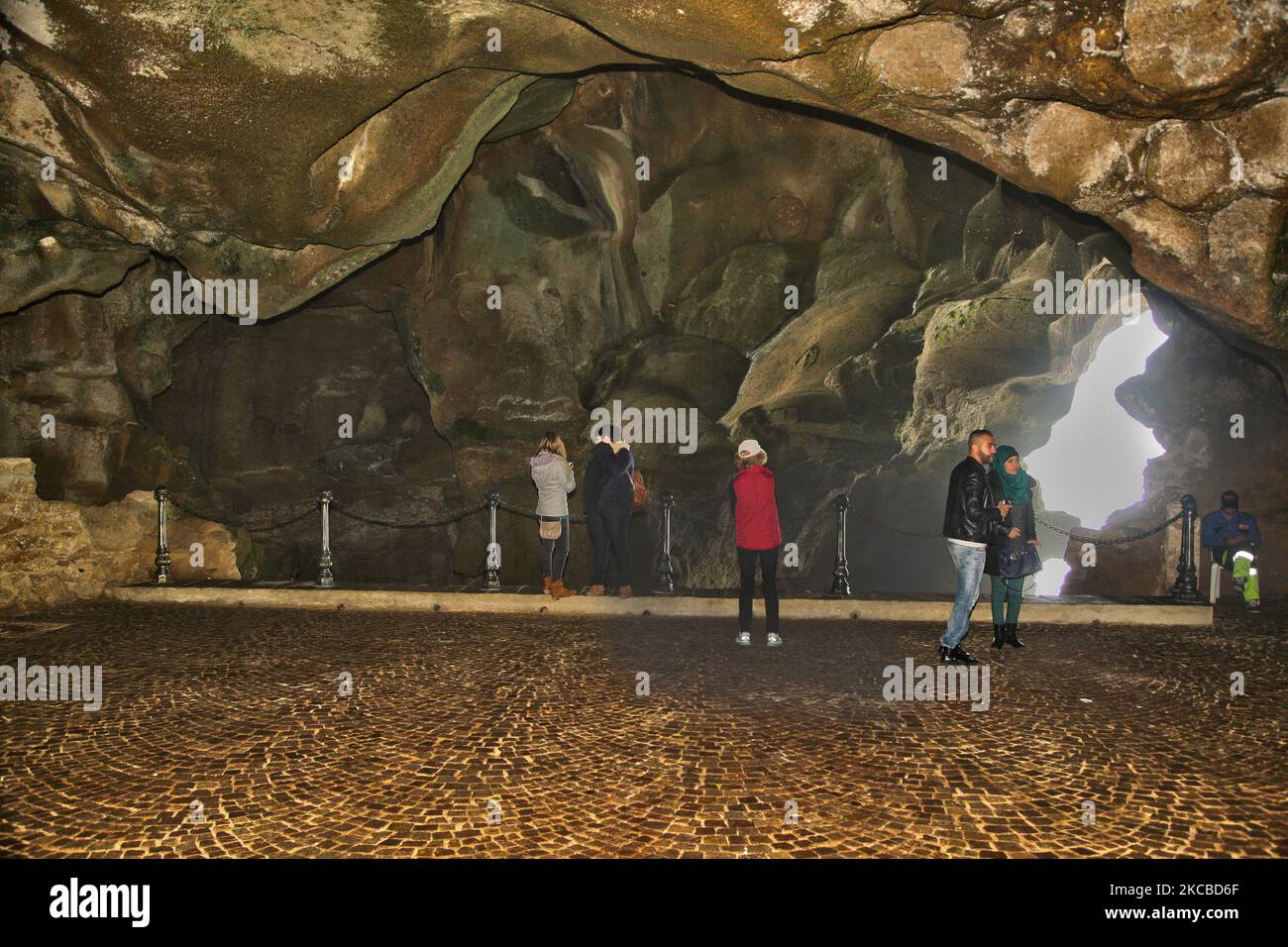 Tourists walk through the Caves of Hercules (Grottes d'Hercule) in ...