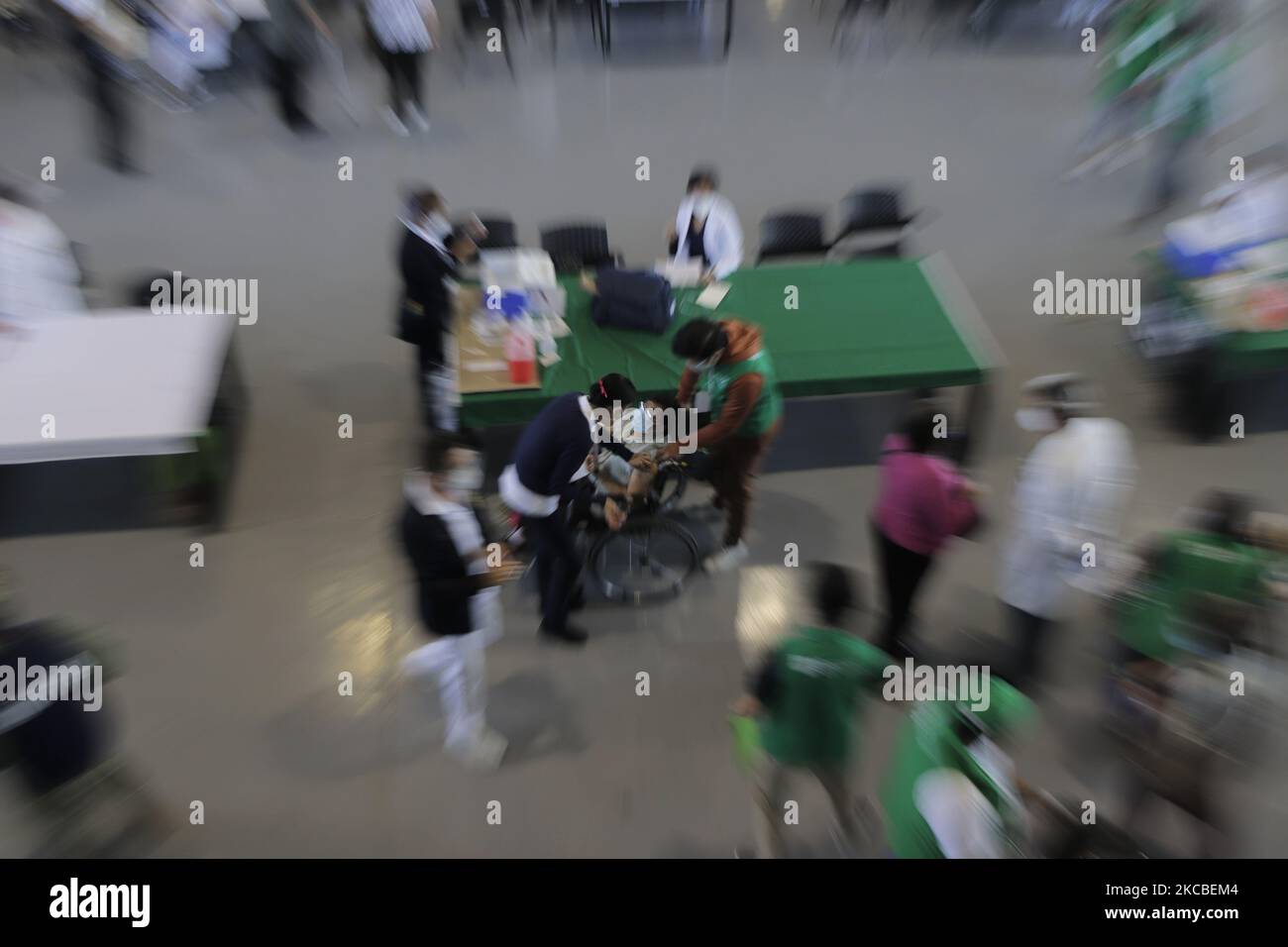 Medical personnel immunize senior citizens with the Pfizer-BioNTech ...