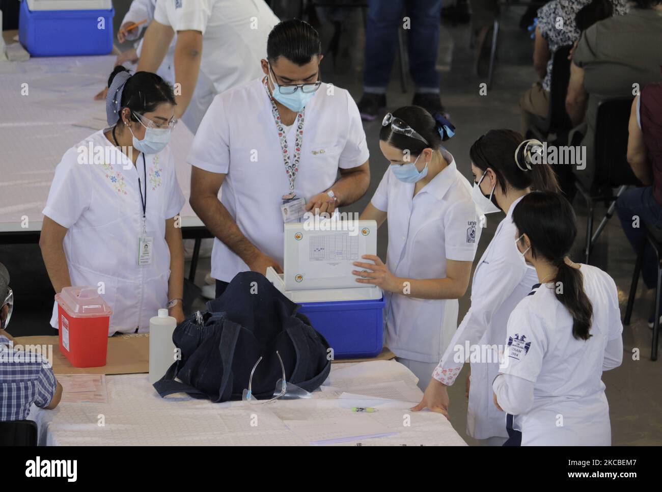 Medical personnel check containers with the Pfizer-BioNTech biologic to ...