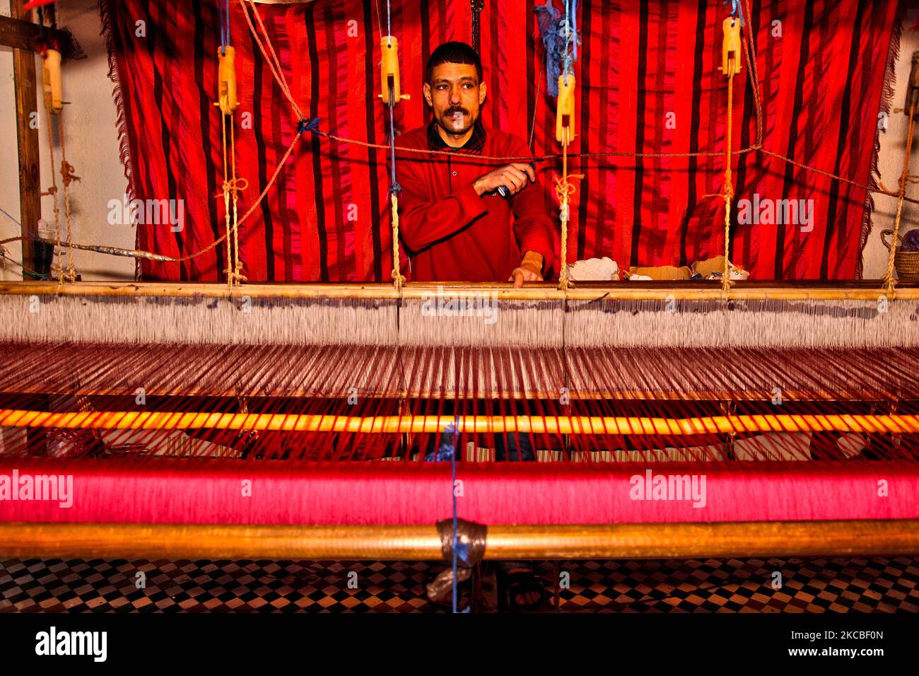 Man weaving cloth made from agave silk on a loom at a workshop in the ...