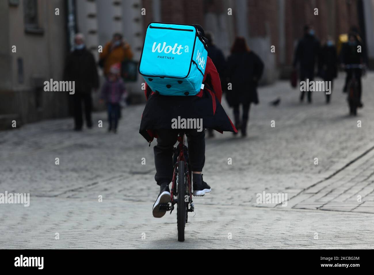 Wolt courier in Krakow, Poland on March 25, 2021. Shopping malls ...