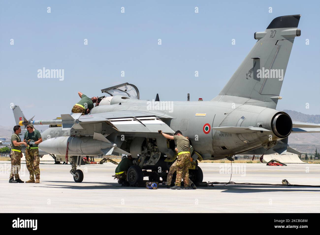 Airmen working on an Italian Air Force AMX aircraft in Konya, Turkey ...