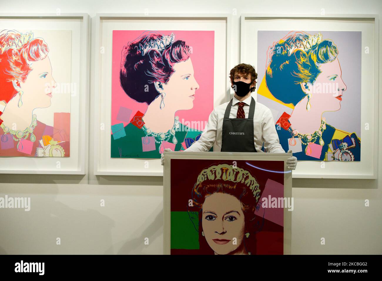 An art handler poses holding 'Queen Elizabeth II, from: Reigning Queens ...