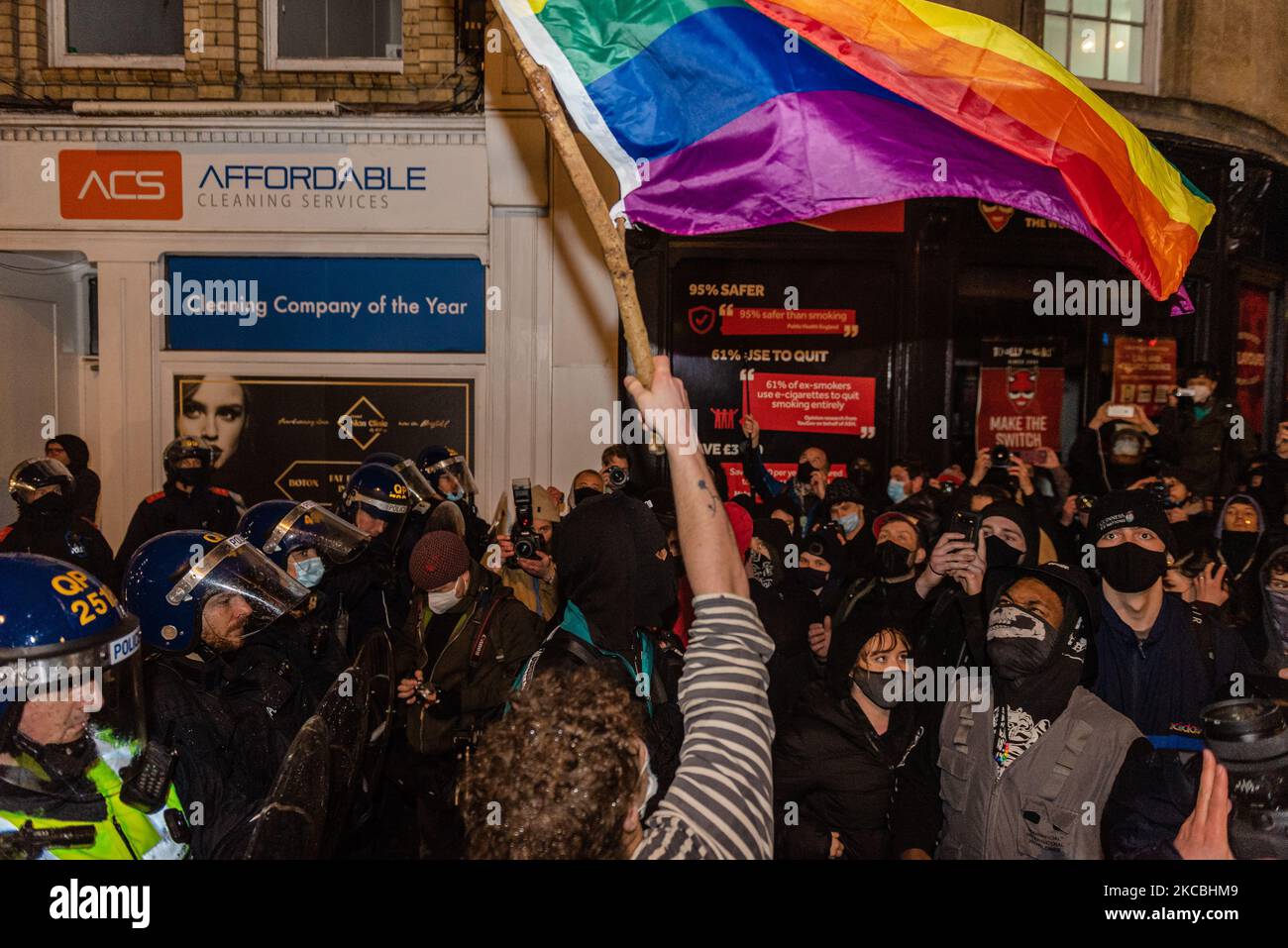 Protester waves rainbow flag hi-res stock photography and images - Alamy