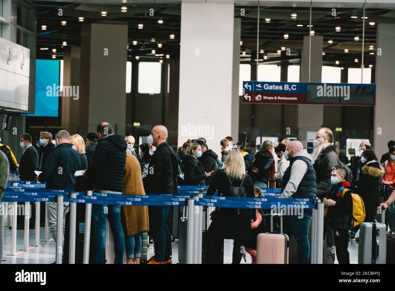 travellers wait in front of Condor check in counter at Duessedorf ...