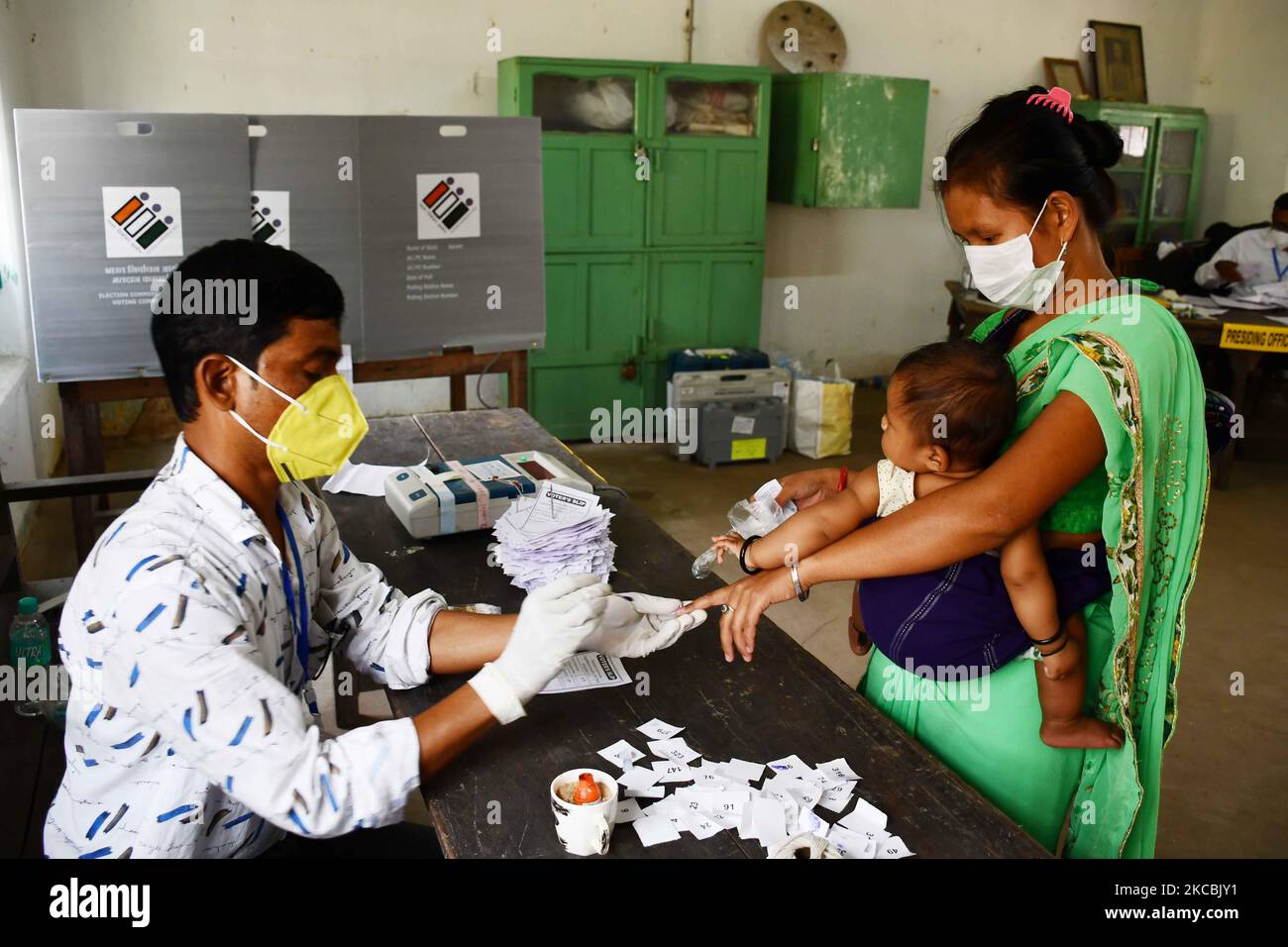 A voter's finger is inked while casting their ballot during first phase ...