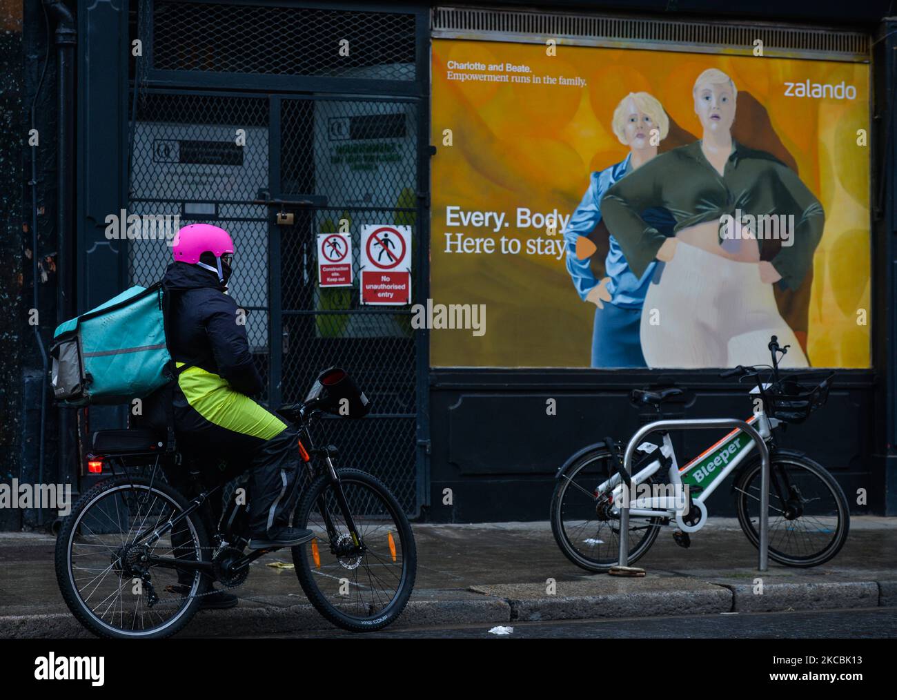 A cyclist looks at a new mural by Irish artists Cormac Dillon (Mack ...