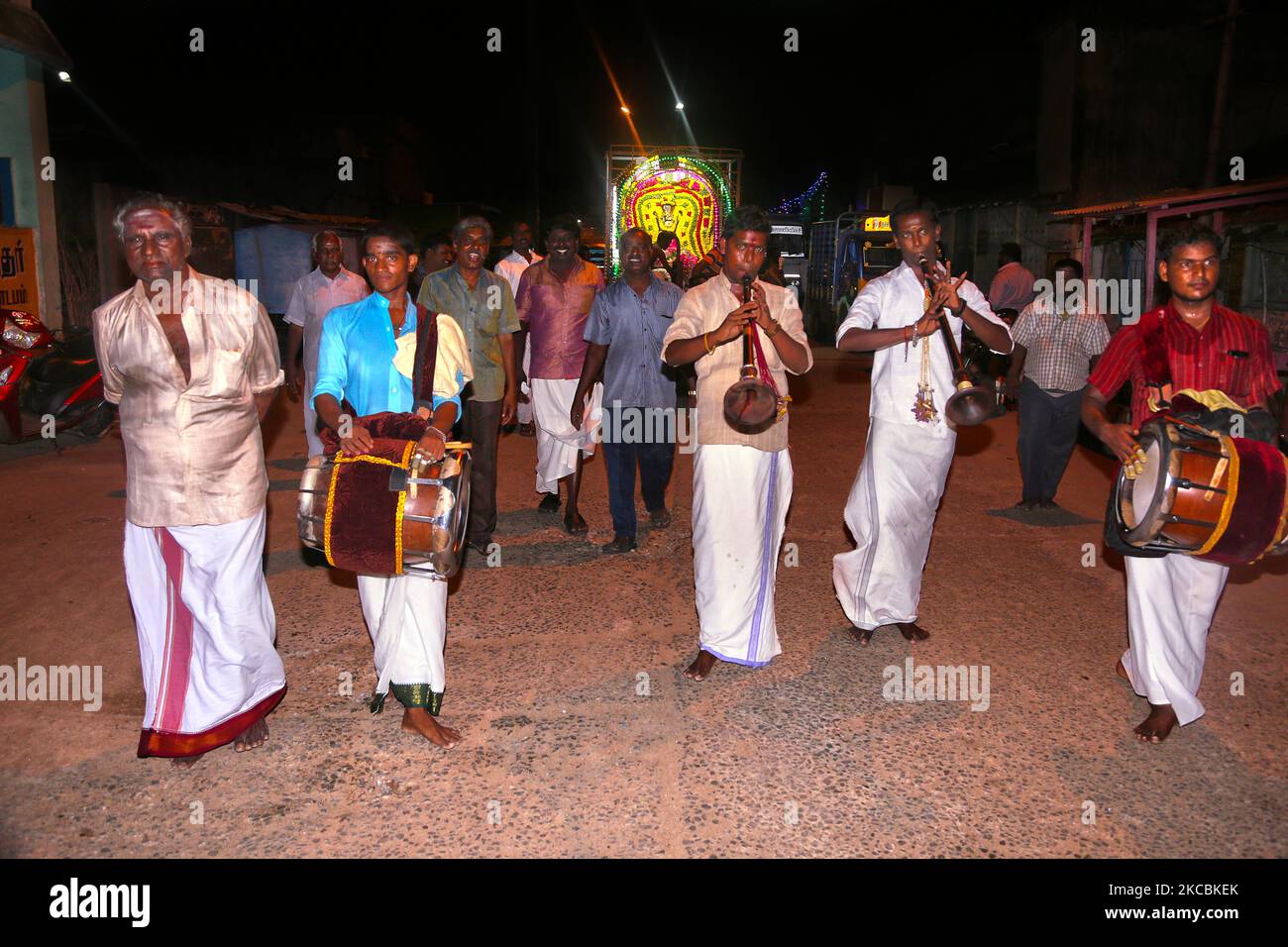 Tamil Hindu musicians playing the nadaswaram and thavil escort an idol ...