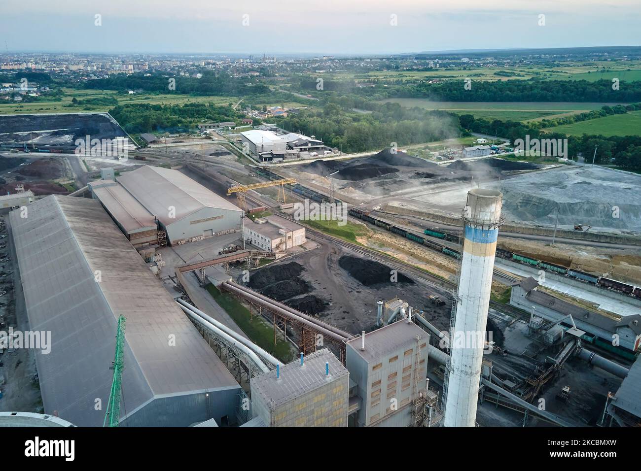 Cement plant with high factory structure and tower cranes at industrial ...