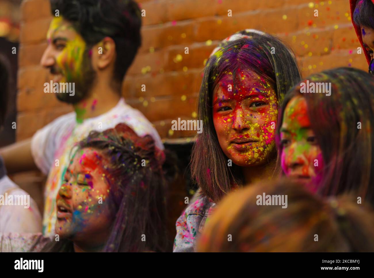 People play with coloured powders as they celebrate Holi, the spring ...