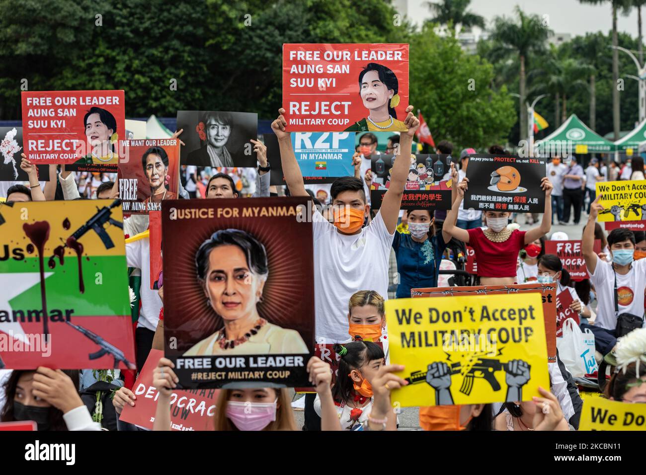 Group of people holding signs with Myanmar official Leader Aung San Suu ...