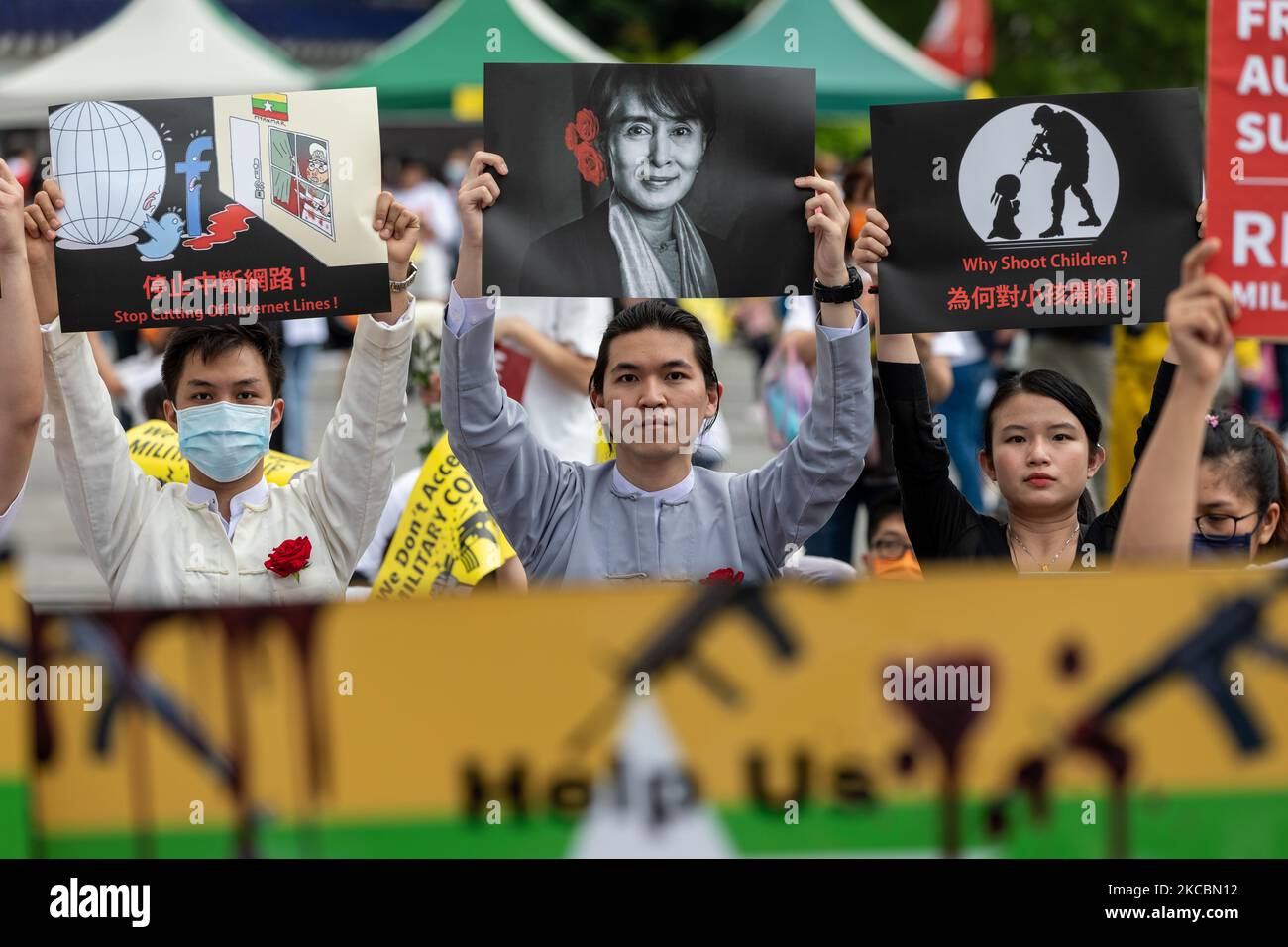 Group of people holding signs with Myanmar official Leader Aung San Suu ...