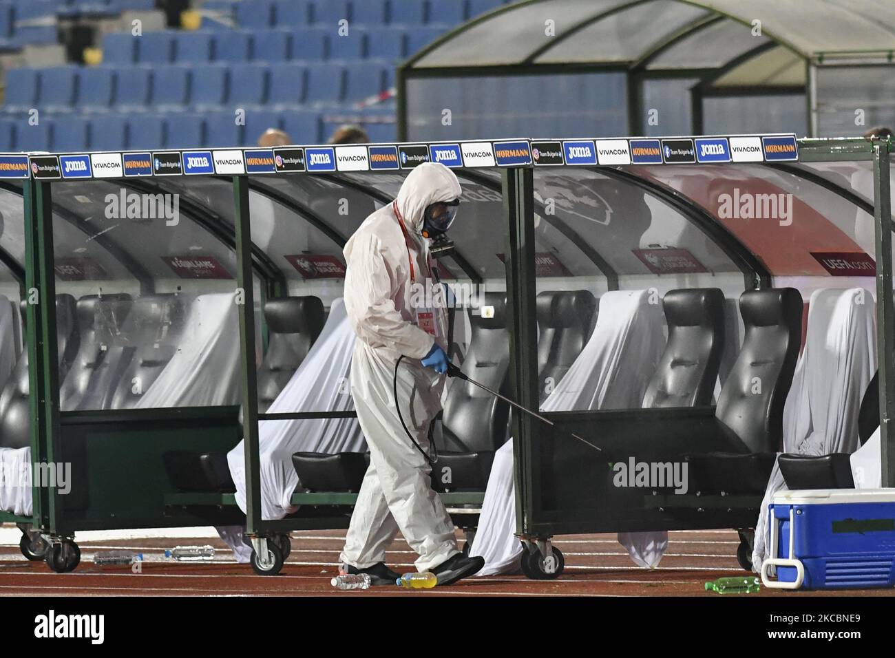 Stadium worker disinfecting substitute bench hi-res stock photography ...