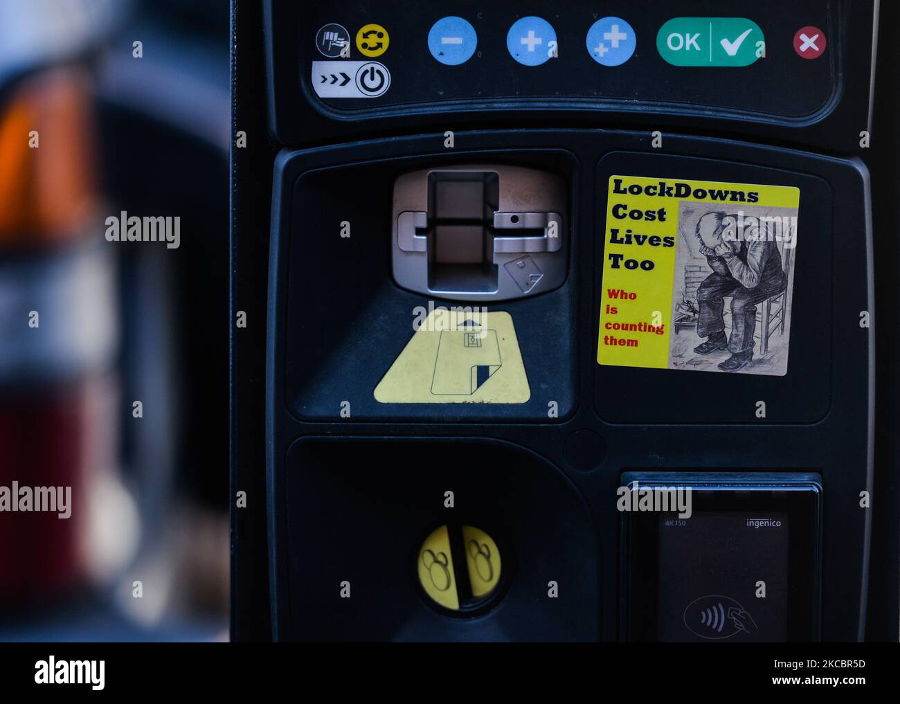 A sticker that reads 'LockDowns Cost Lives Too' seen on a Parking meter ...