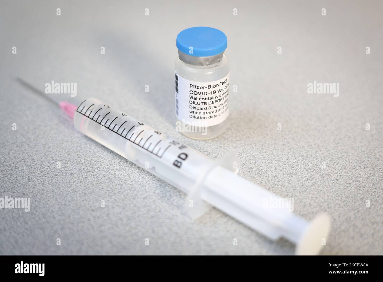 A vial with a Pfizer label is seen with a syringa and needle in this ...