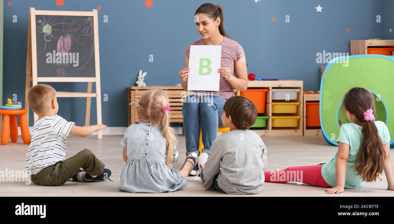 Cute little children learning letters in kindergarten Stock Photo - Alamy
