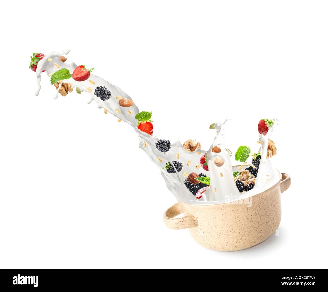 Pot with splashing milk, sweet oatmeal, falling berries and nuts on ...
