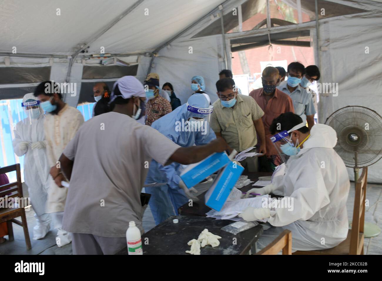 Health worker during work inside a sample collection booth for covid-19 ...