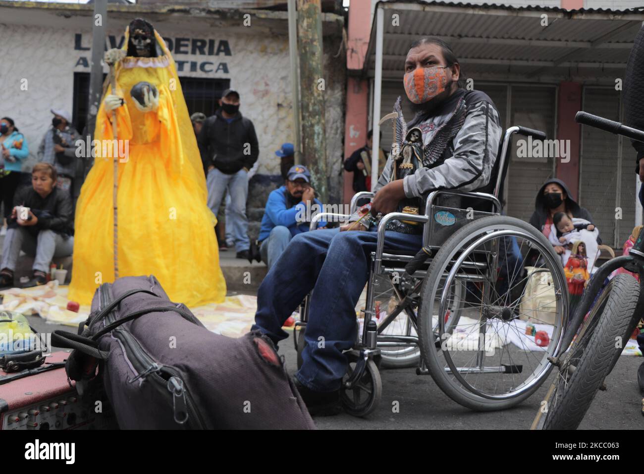 A disabled person in a wheelchair and follower of Santa Muerte, also ...