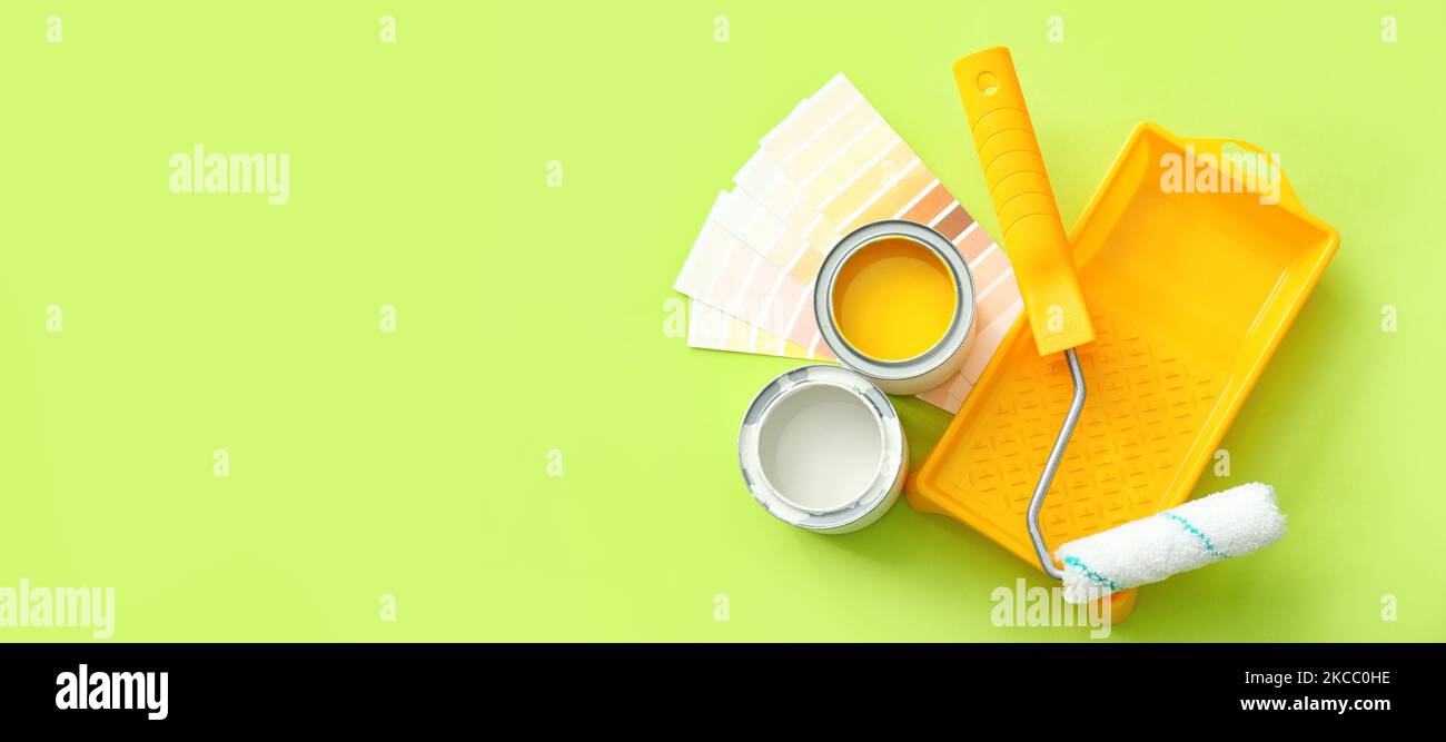 Composition with cans of paint, roller, tray, color patterns and brush ...