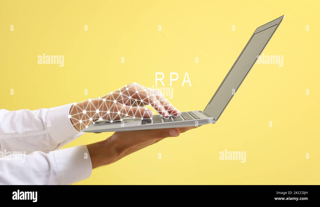 Male hands with modern laptop on yellow background. Concept of robotic ...