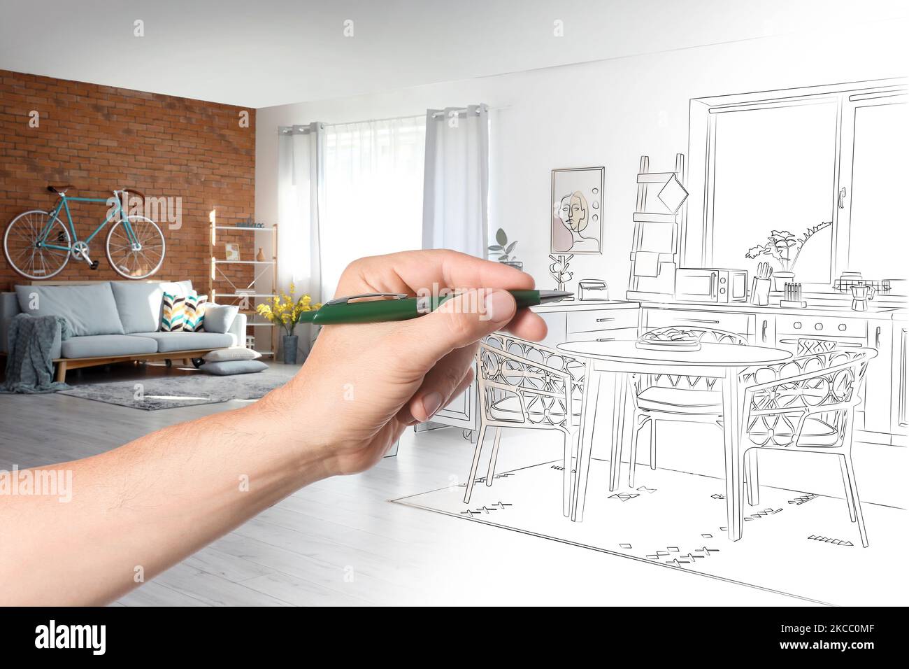 Male designer drawing new interior of studio apartment Stock Photo - Alamy