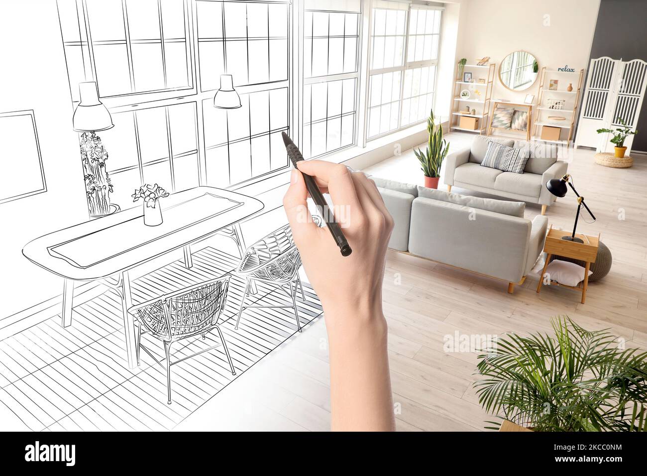 Female designer drawing new interior of studio apartment Stock Photo ...