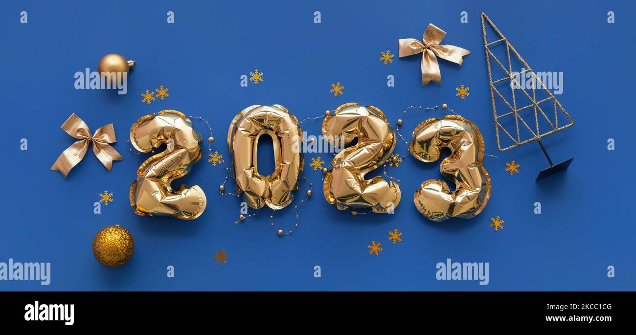Figure 2023 made of balloons and Christmas decorations on blue ...
