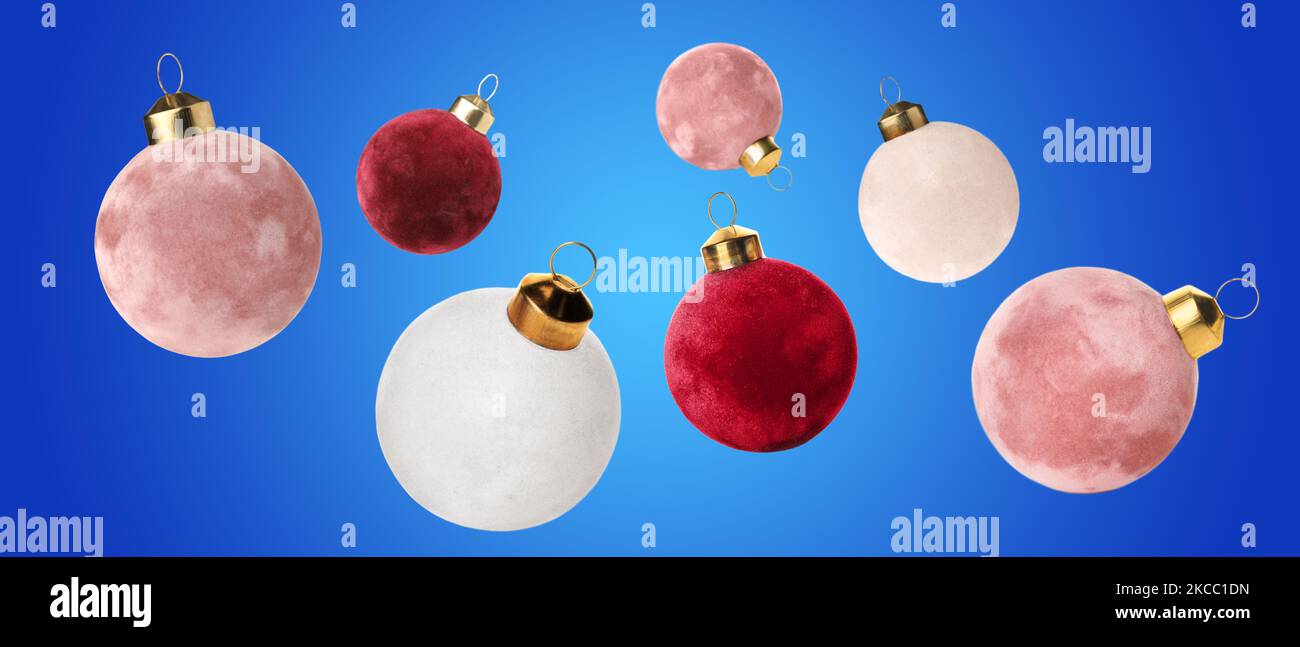 Flying Christmas balls on light blue background Stock Photo - Alamy