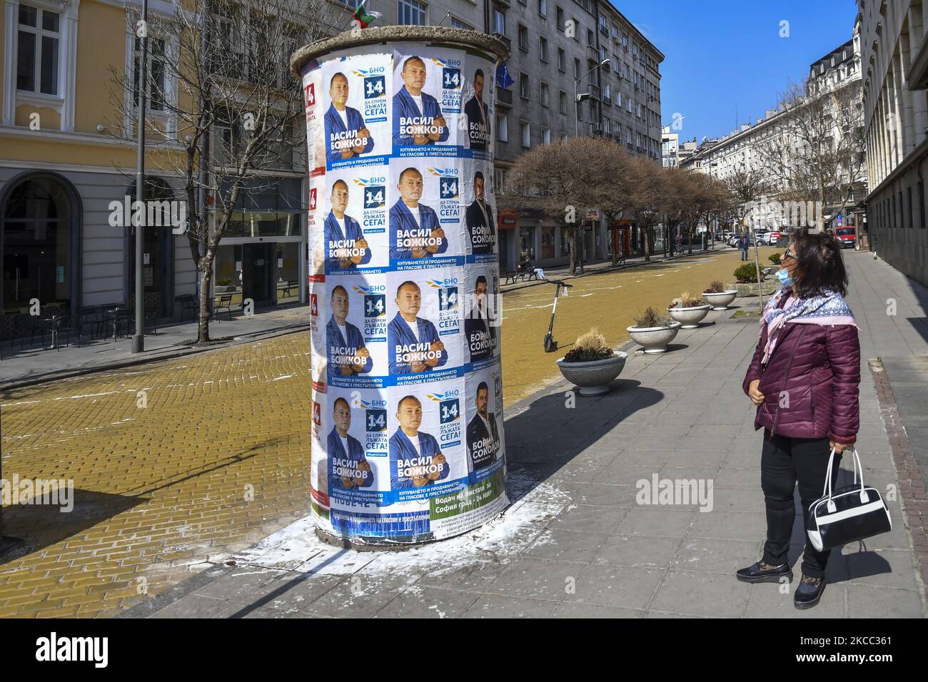 Woman looking at campaign posters of candidates for the upcoming ...