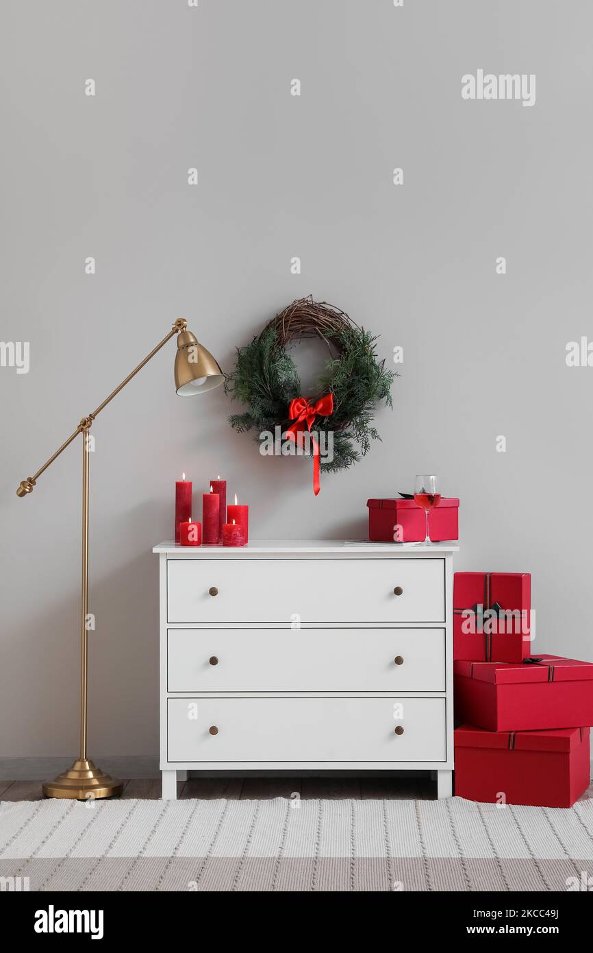 Stylish interior of living room with Christmas wreath and burning ...